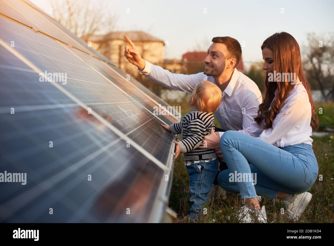 Side view shot of a young modern family with a little baby boy getting ...
