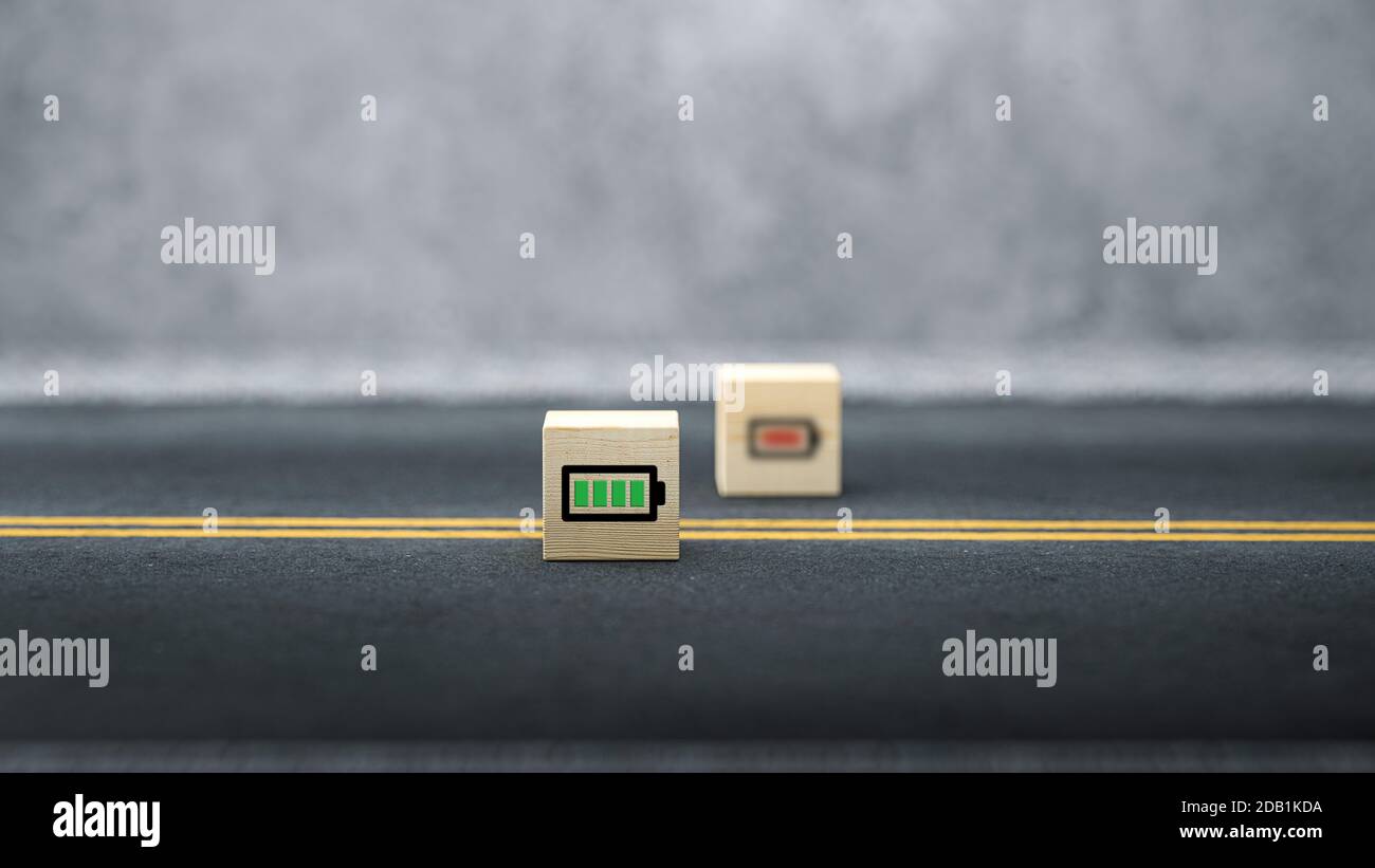 cube with full charged battery symbol and a cube out of focus with low ...