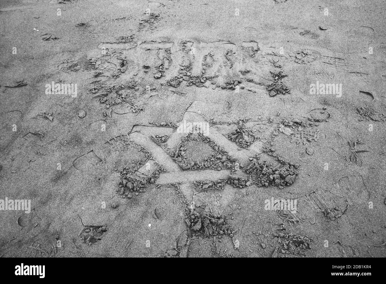 Star of David drawn on the sand beach in Tel Aviv, Israel and over it ...
