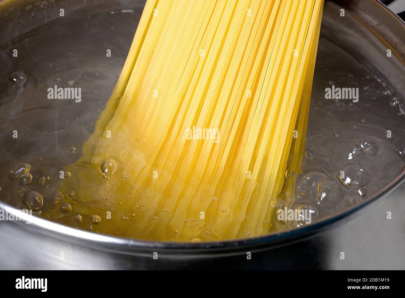 cooking spaghetti in hot water Stock Photo - Alamy