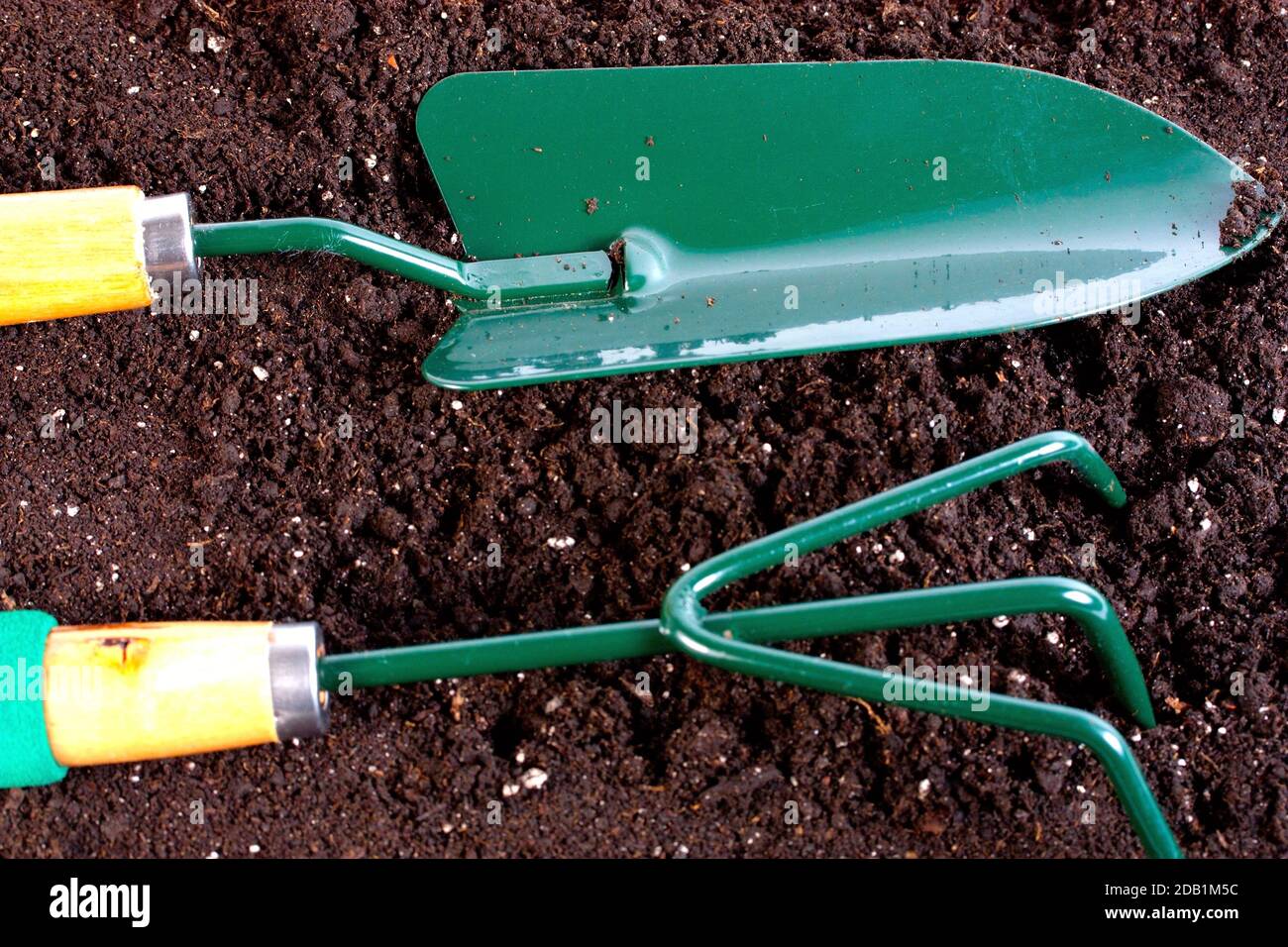 Garden tool with heap of organic compost background Stock Photo - Alamy