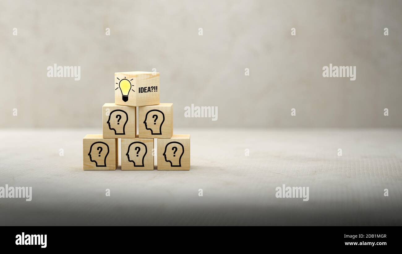 cubes showing message IDEA? and a brainstorming session on concrete ...