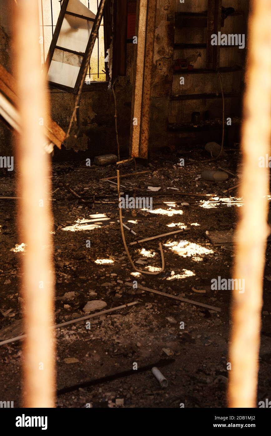 Destroyed office in abandoned building. Sun rays light up messy ...