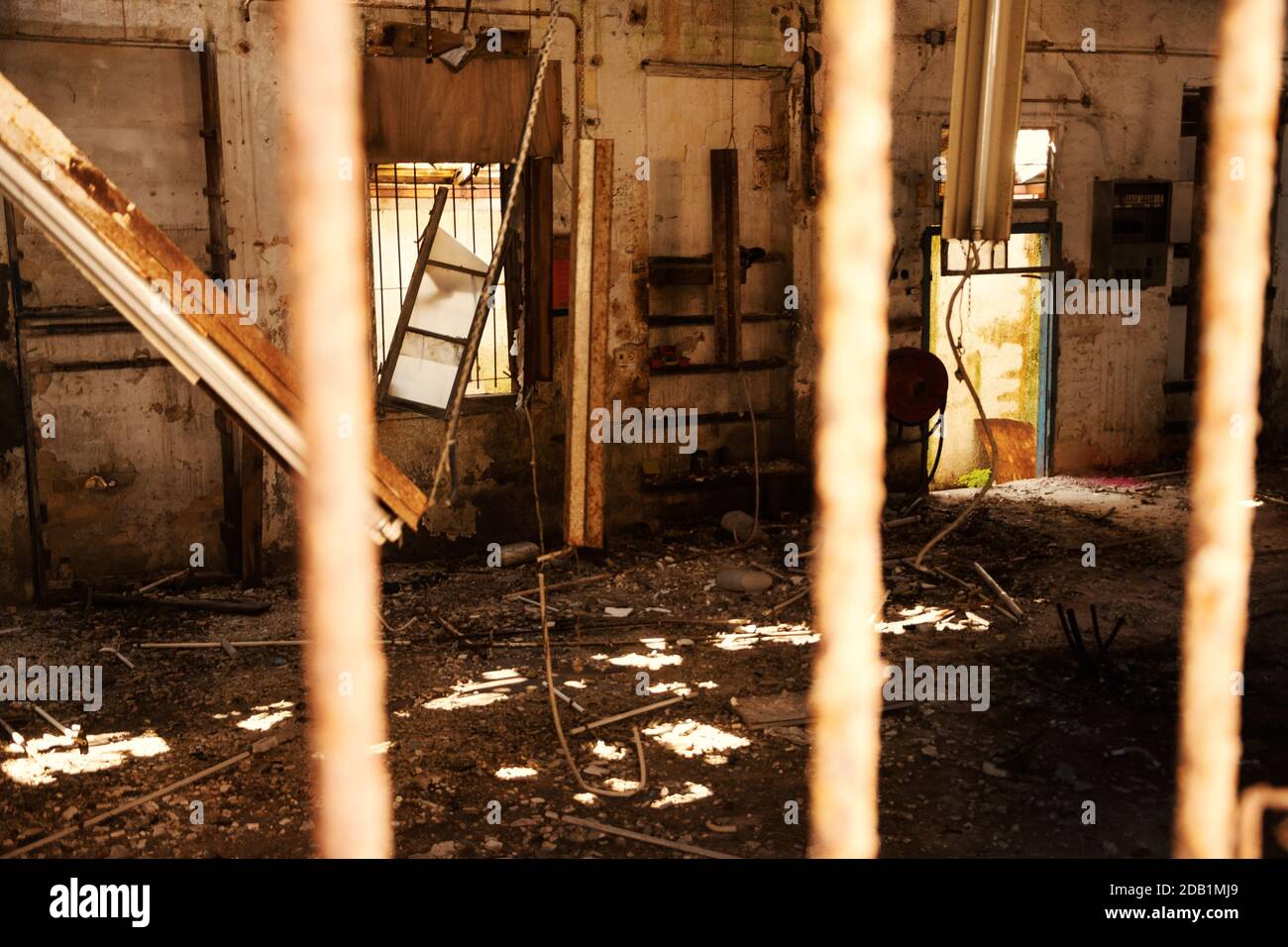 Destroyed office in abandoned building. Sun rays light up messy ...