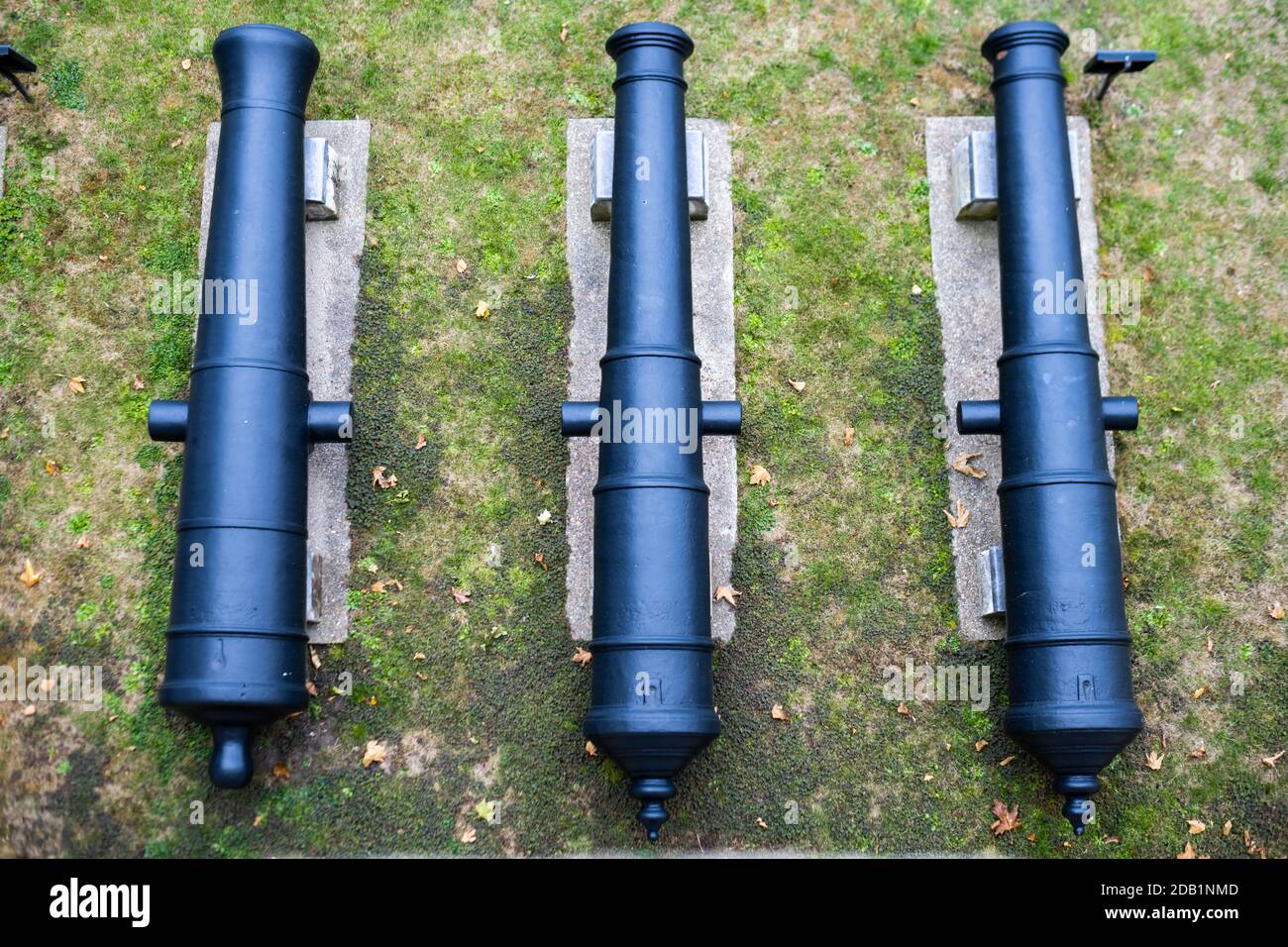 Top down image of three cannons in a row outside the Tower of London ...