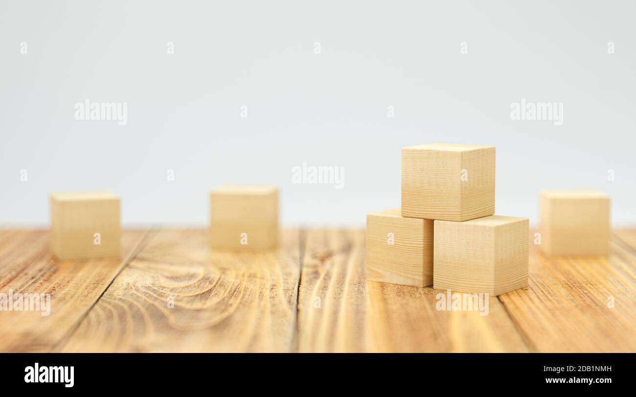 empty wooden cubes for own messages and icons on wooden floor and white ...