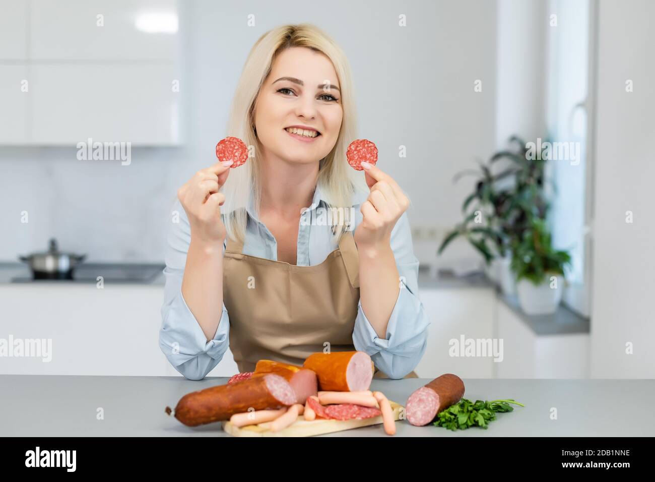 Young woman eating sausage model hi-res stock photography and images ...