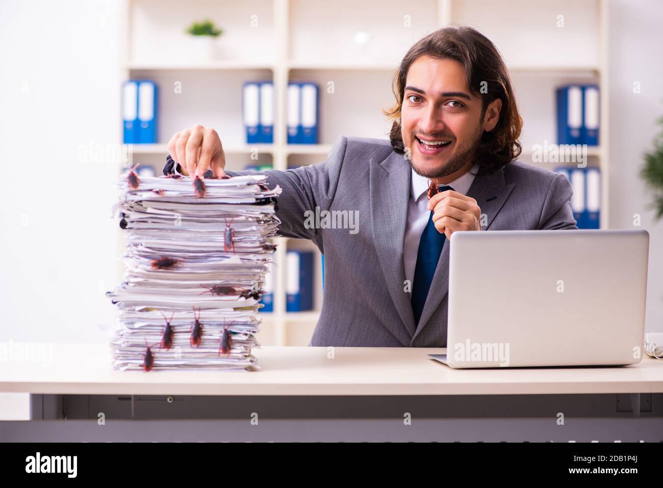 Young employee and too many cockroaches in the office Stock Photo - Alamy