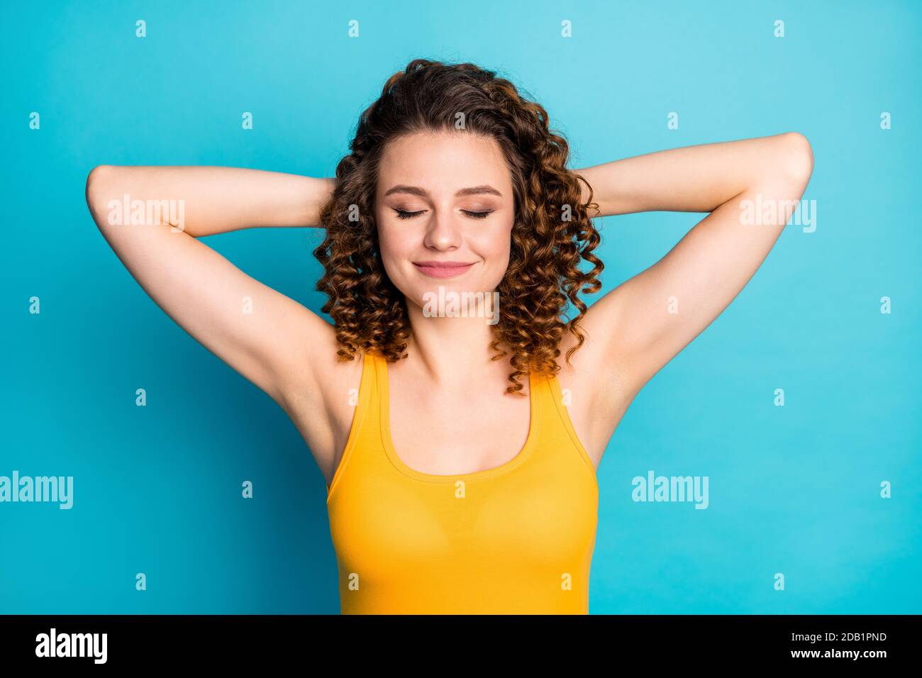 Photo of charming cute young girl hands behind head smiling nap eyes ...