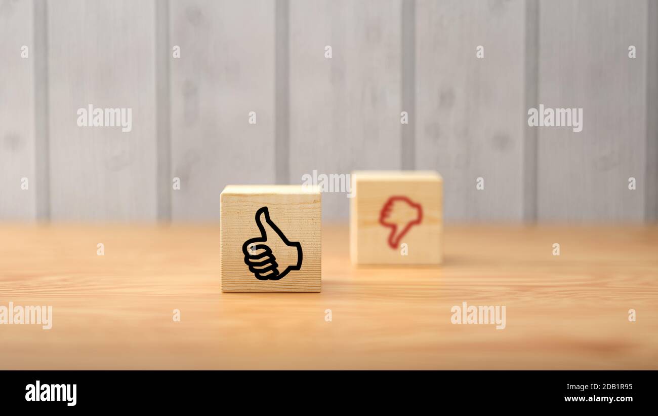 cubes with thumbs-up symbol in focus and thumbs-down out of focus on ...