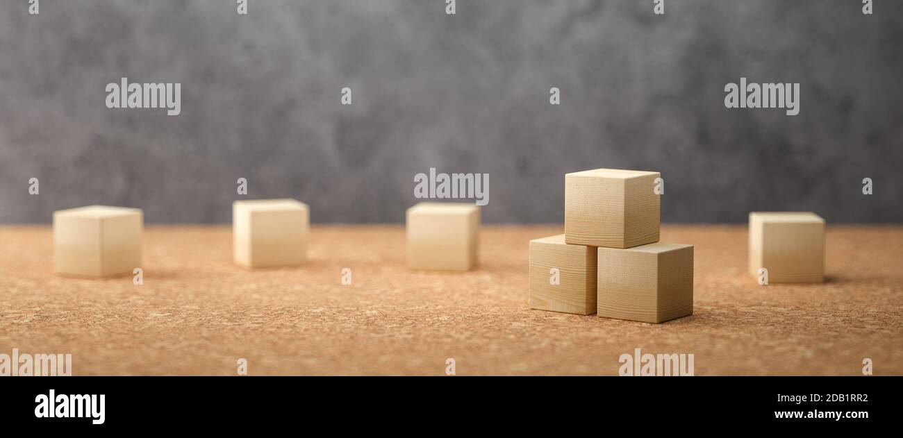 empty wooden cubes for own messages and icons on cork floor in front of ...