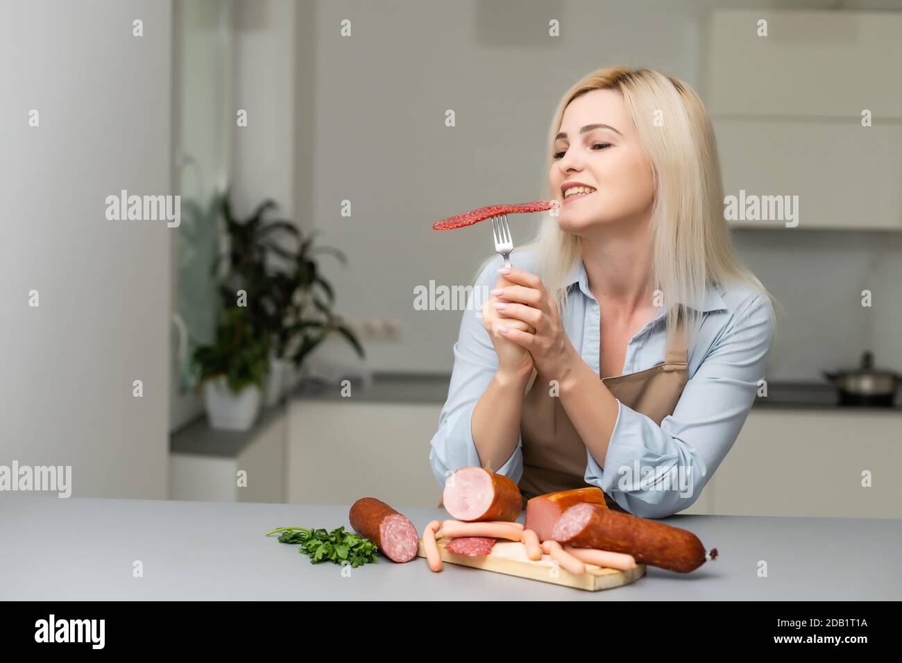Young woman eating sausage model hi-res stock photography and images ...