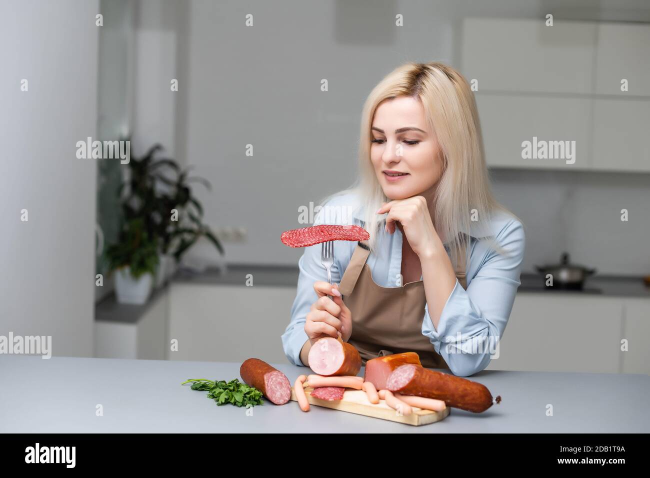 Woman eating pork sausage hi-res stock photography and images - Alamy