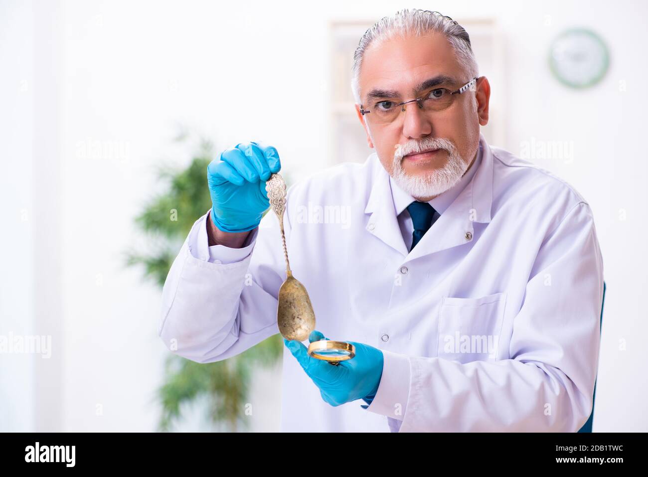 Old male archaeologist working in the lab Stock Photo - Alamy