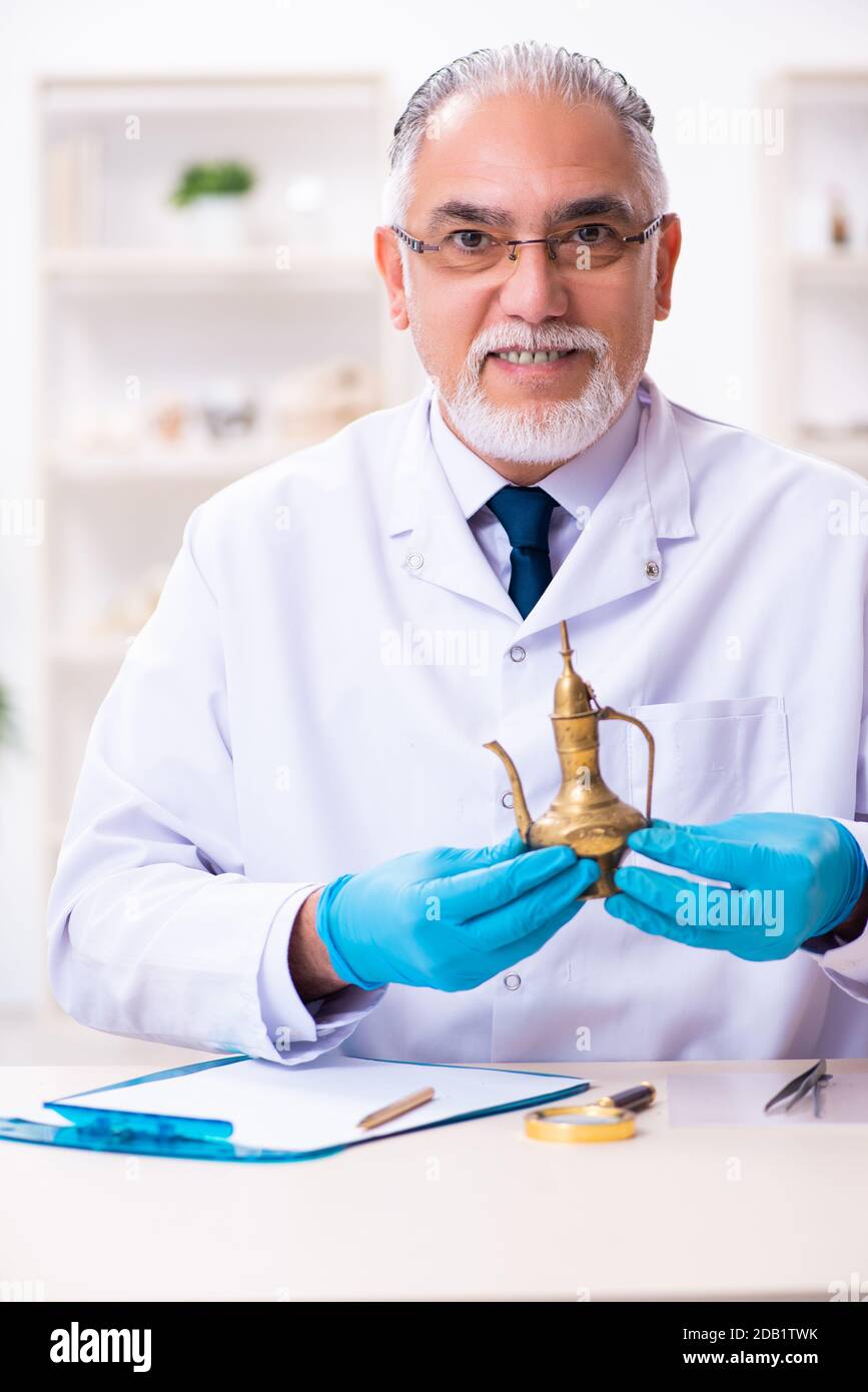 Old male archaeologist working in the lab Stock Photo - Alamy
