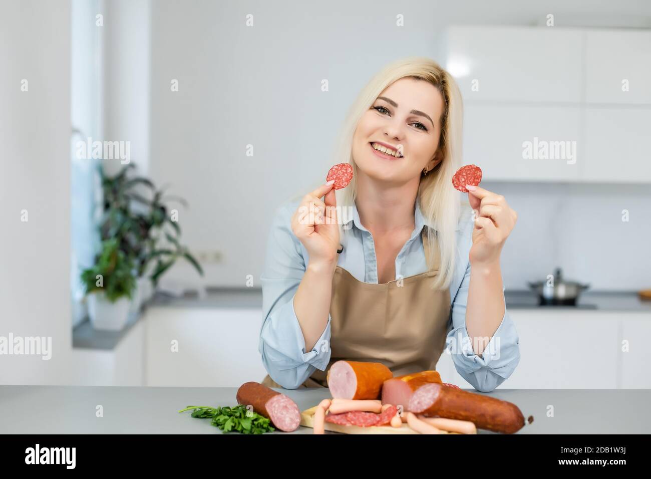 Young woman eating sausage model hi-res stock photography and images ...