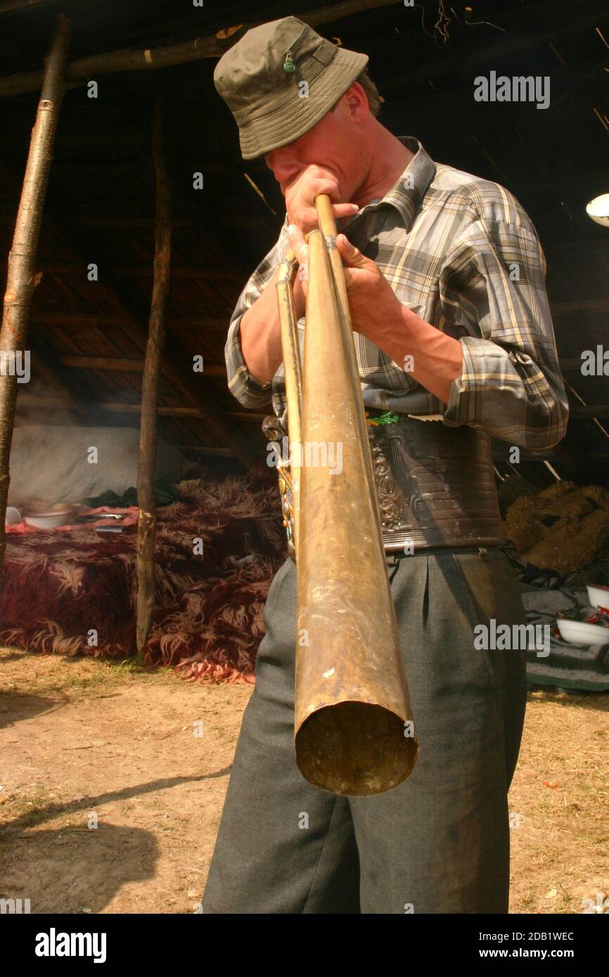 Man in Romania's countryside with a handcrafted bugle Stock Photo - Alamy
