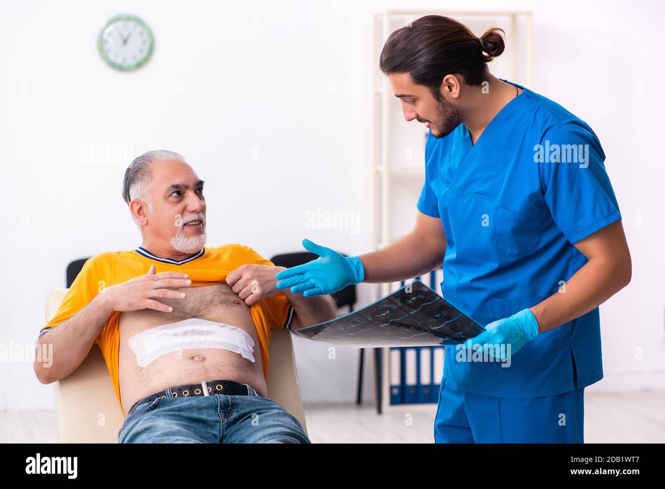 Old man visiting male doctor Stock Photo - Alamy