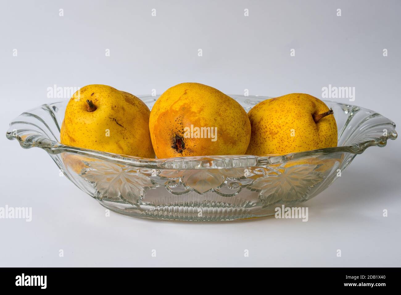 Still life with three yellow pears in an antique glass bowl Stock Photo ...