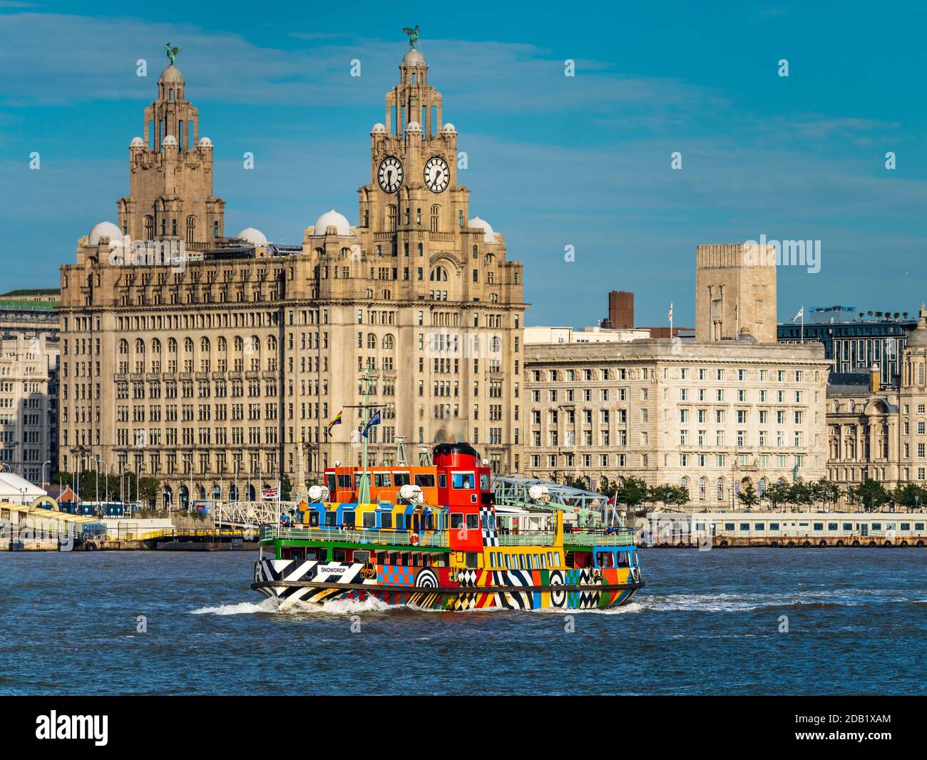 Dazzle painted Mersey Ferry Snowdrop passes the Liverpool Royal Liver ...