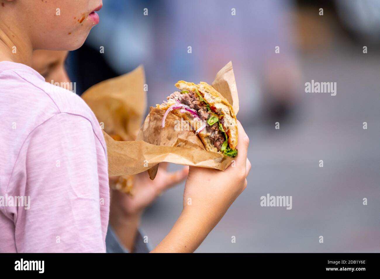 Anonymous child with delicious burger Stock Photo - Alamy