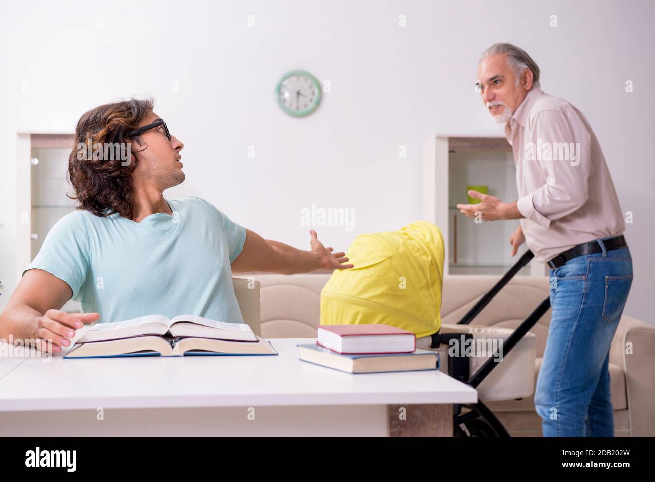 Old grandfather looking after newborn at home Stock Photo - Alamy