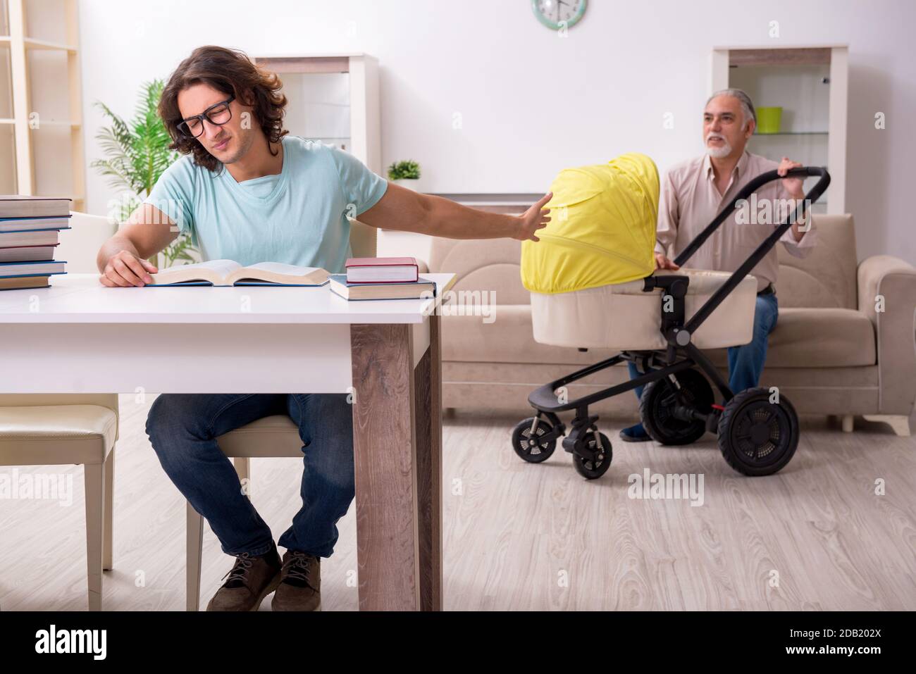 Old grandfather looking after newborn at home Stock Photo - Alamy