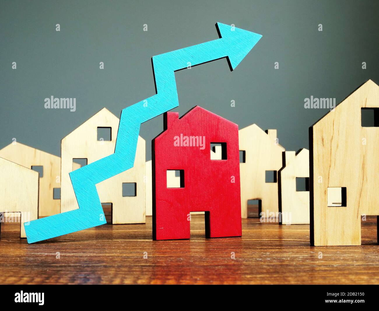 Real estate invest. Wooden homes and rise arrow as symbol of property ...