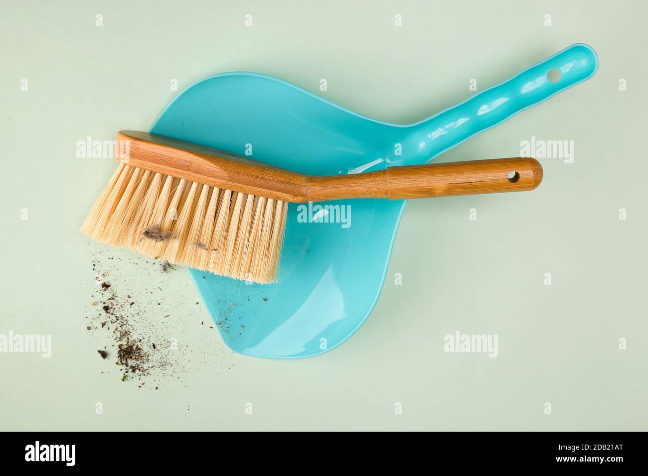 Dustpan and brush and a pile of dust and dirt, top view. House chores ...