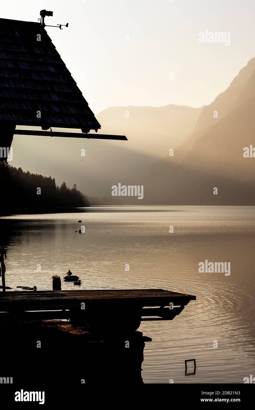 House by the water at sunset. Bohinj lake (Bohinjsko jezero). Triglav ...