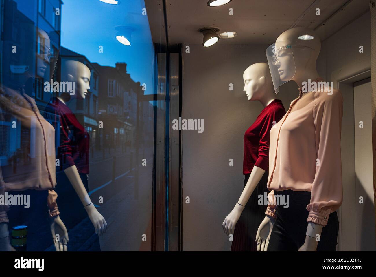 Mannequins wearing face screens, sign of covid 19 times, in a shop ...