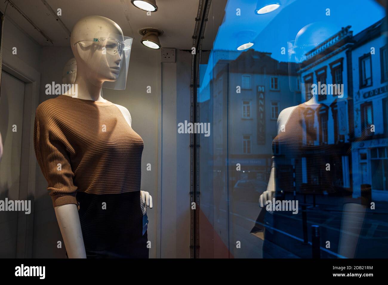 Mannequins wearing face screens, sign of covid 19 times, in a shop ...