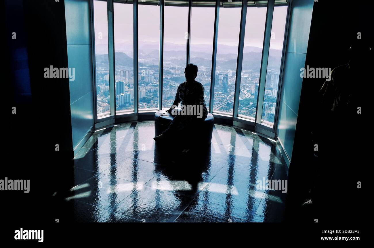A woman at Petronas Twin Towers Observation Deck to view Kuala Lumpur ...