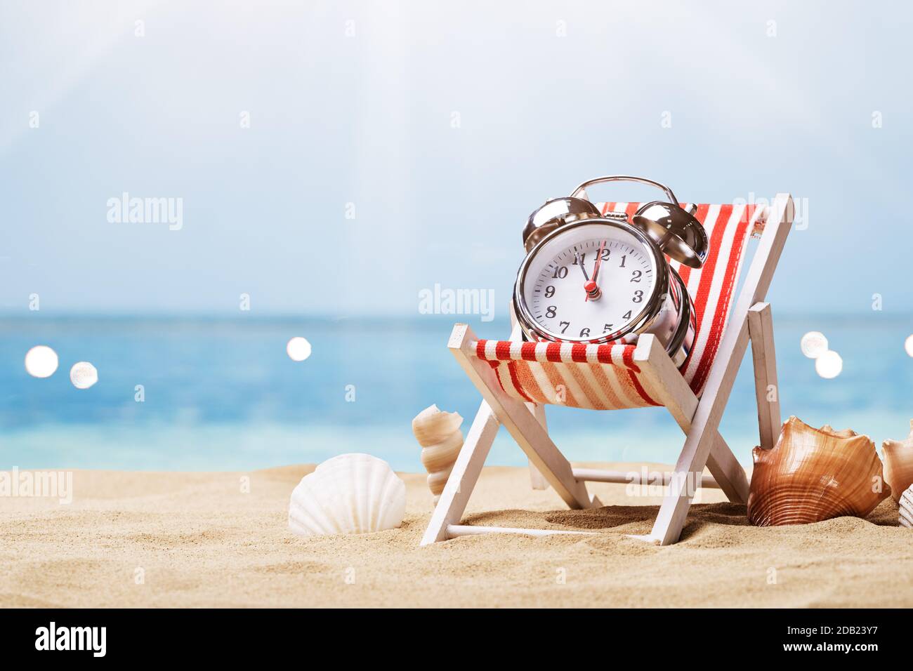 Alarm Clock On Deck Chair On Sunny Tropical Beach Stock Photo - Alamy