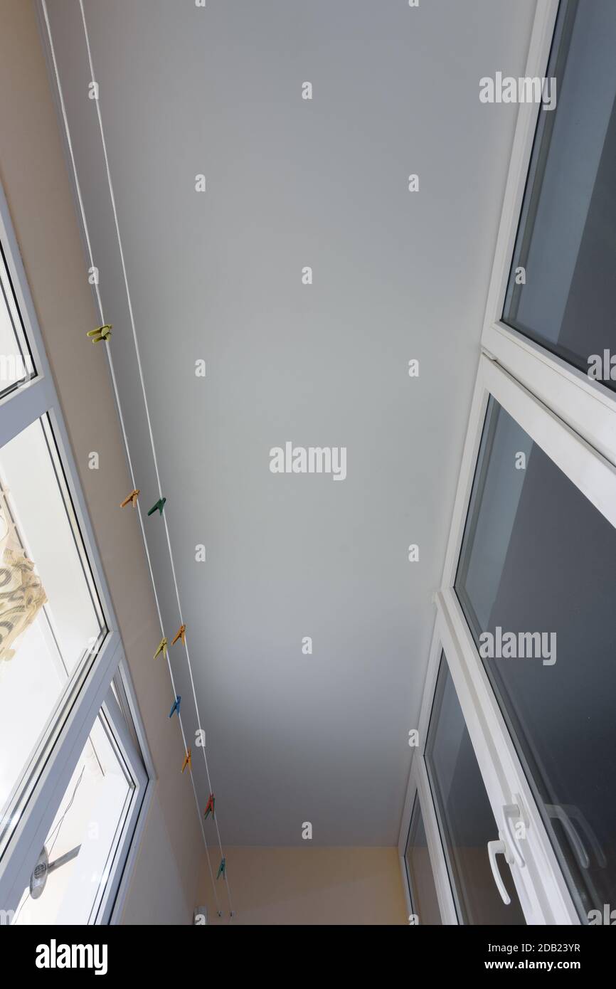 View of the white matte stretch ceiling on the loggia in the apartment ...