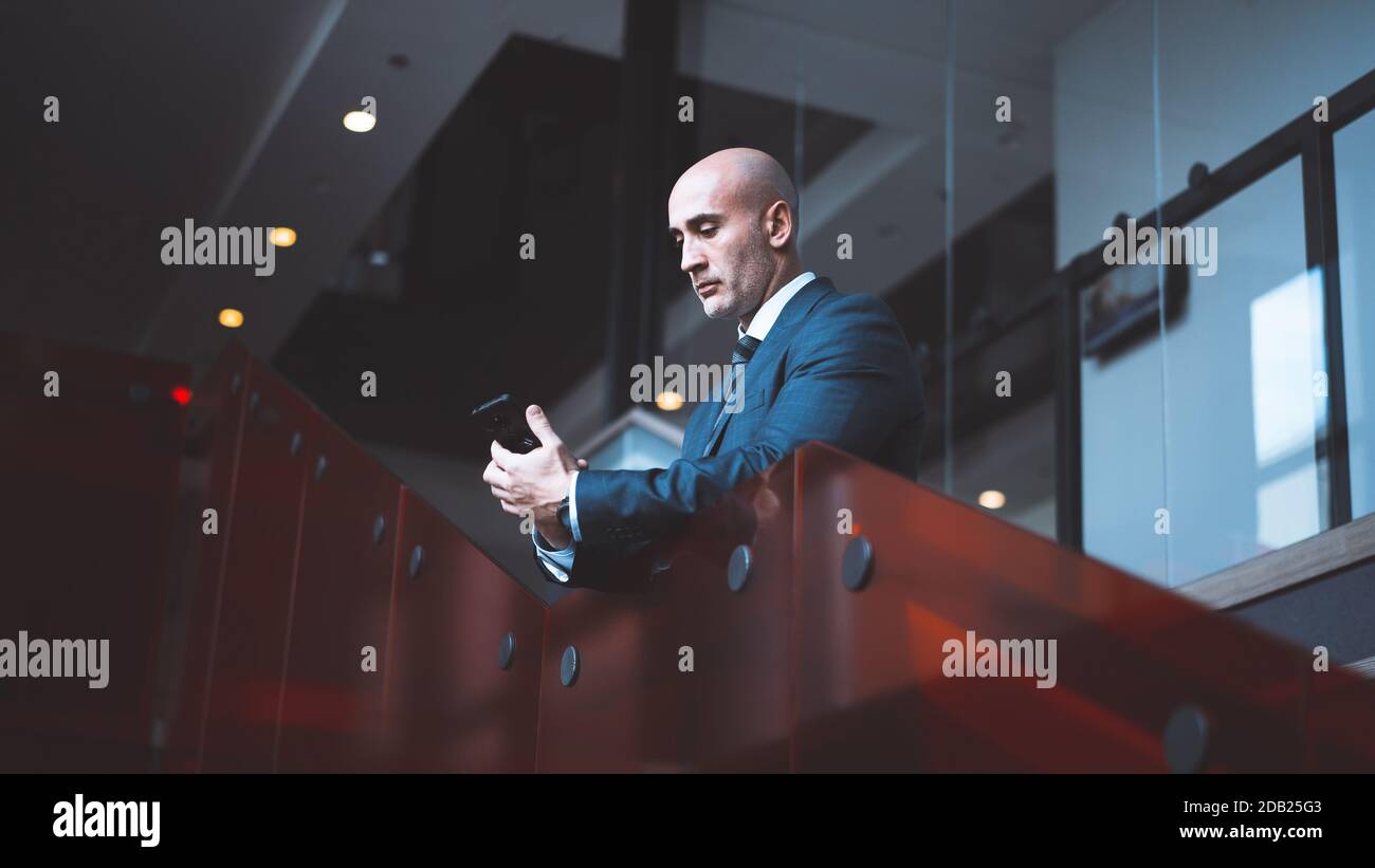 Serious Caucasian businessman holds meeting online using phone. Bottom ...