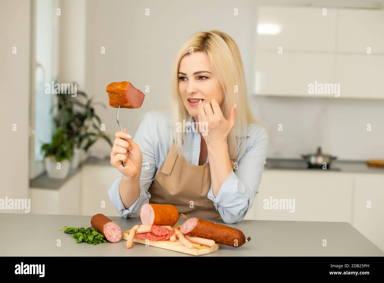 Young woman eating sausage model hi-res stock photography and images ...