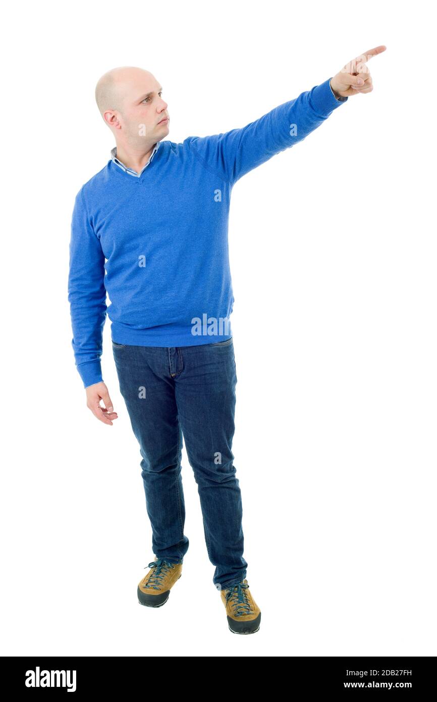 young casual man full body, pointing, isolated on a white background ...