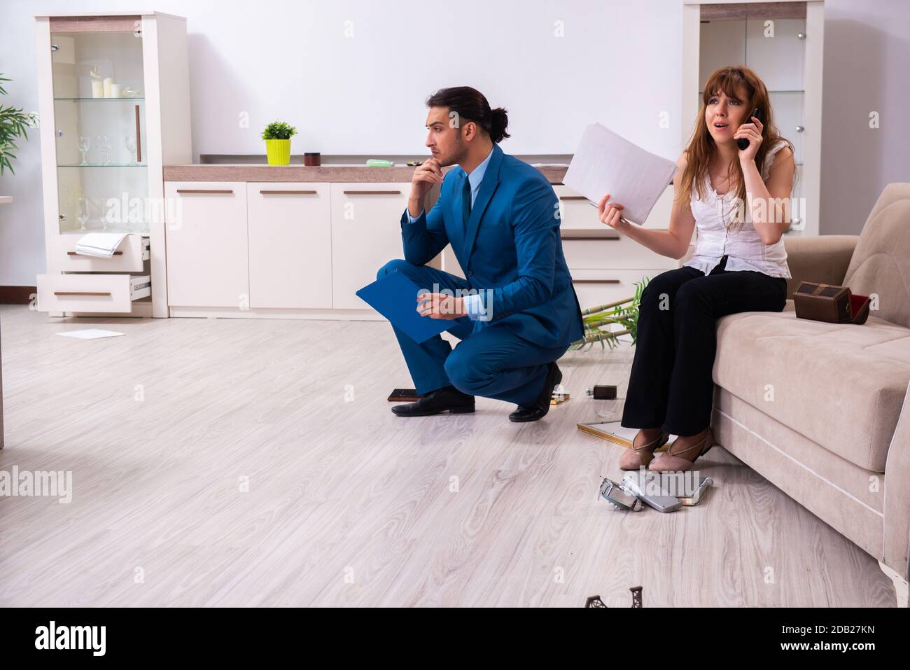 Female owner and police officer in housebreaking concept Stock Photo ...