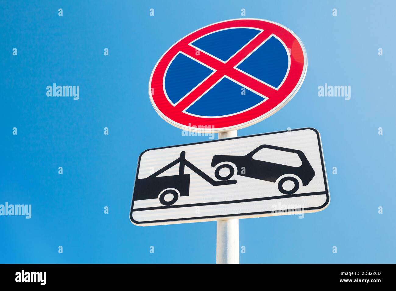 No stopping and evacuation of cars. Road signs against blue sky Stock ...