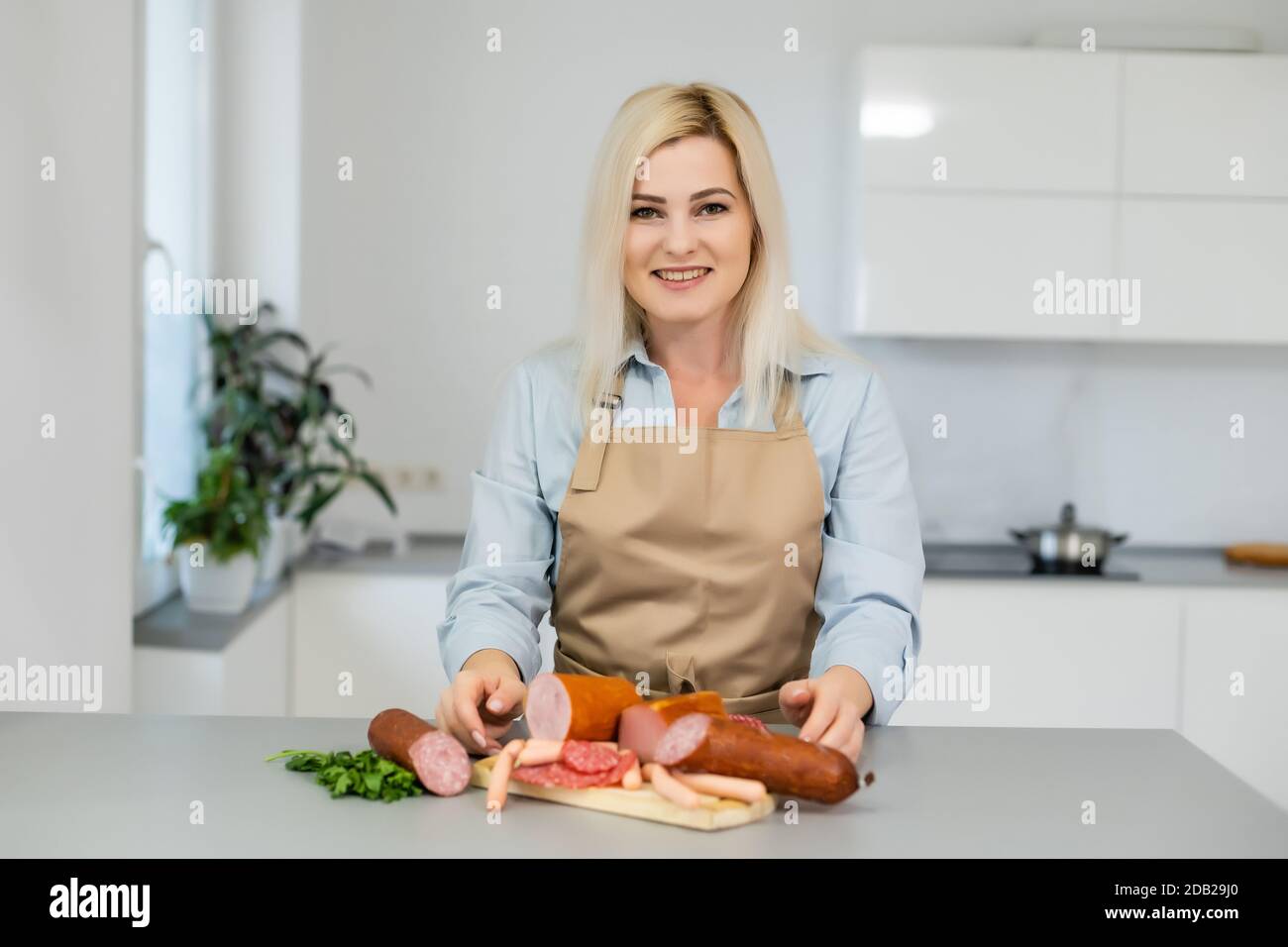 Young woman eating sausage model hi-res stock photography and images ...