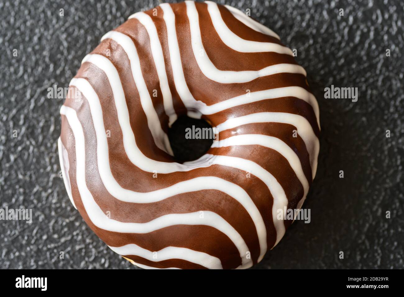 Chocolate donut on black surface Stock Photo - Alamy