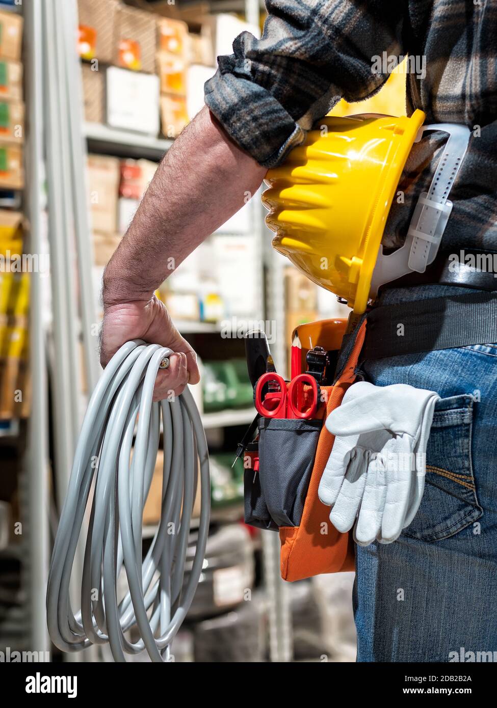 Electrician in the electrical component store holds the roll of ...