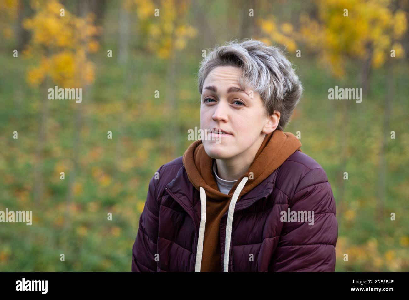 New femininity - gender neutral style. Young woman with stylish short ...