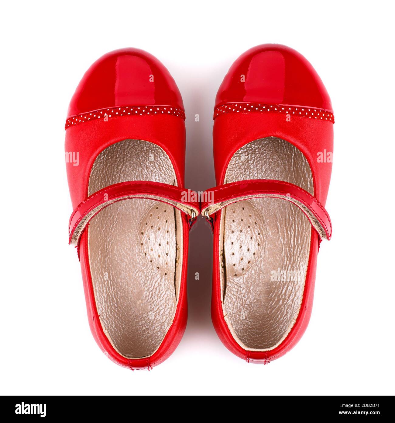 Children's red leather shoes for girls on a white background. Photo for shoes advertisement. Top ...
