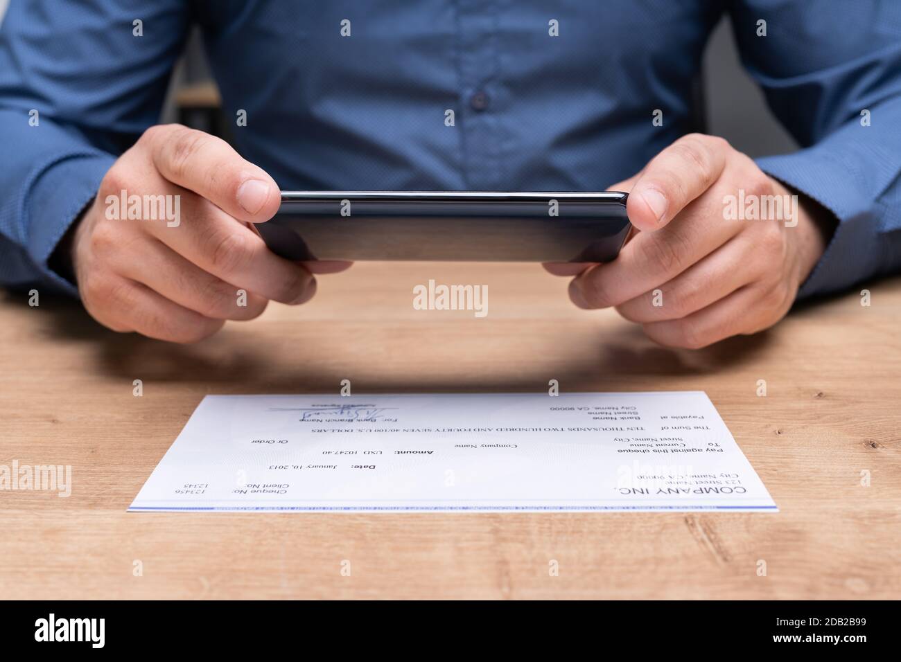 Man Taking Photo Of Cheque To Make Remote Deposit In Bank Stock Photo ...