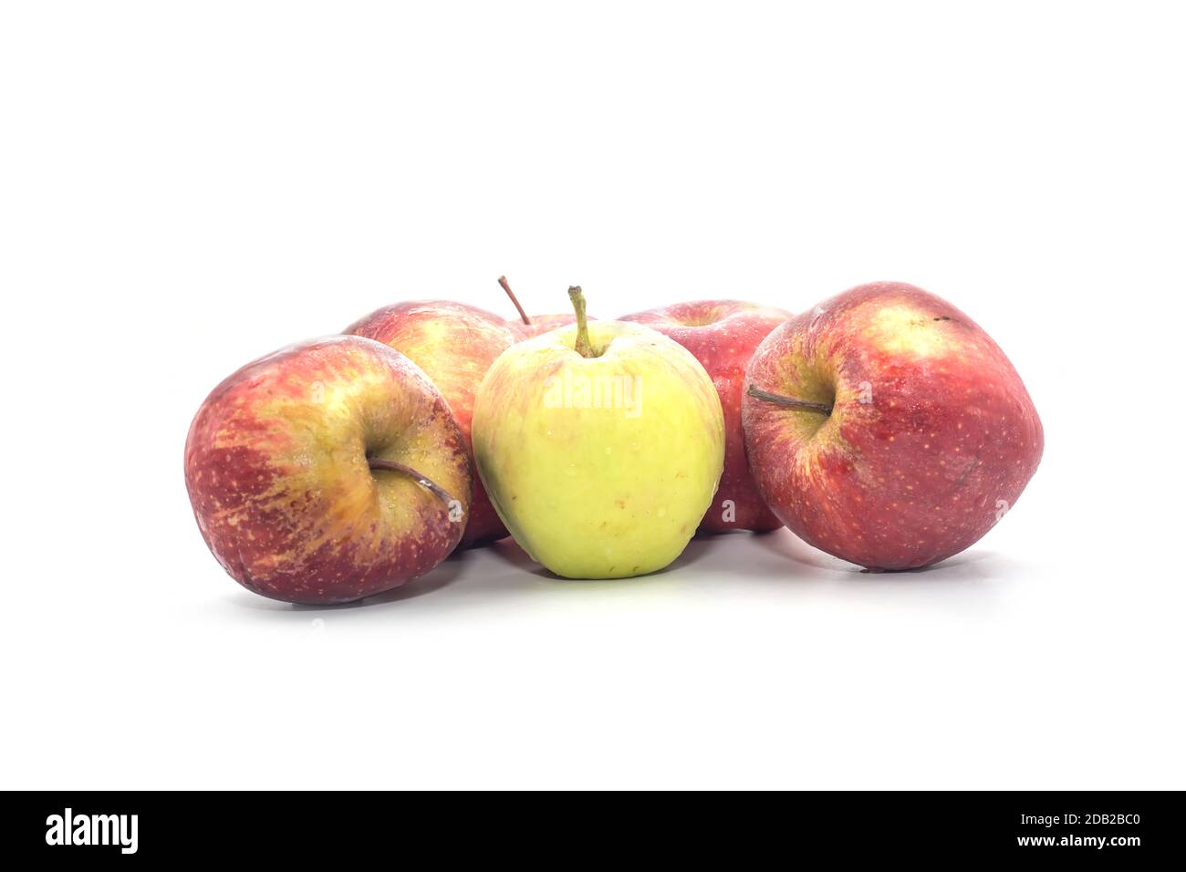 green apple standing out from large group of red apple Stock Photo - Alamy