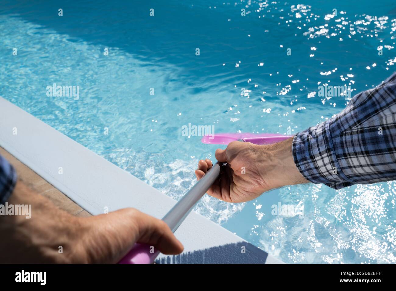 Male Worker In Uniform Cleaning Swimming Pool Stock Photo - Alamy