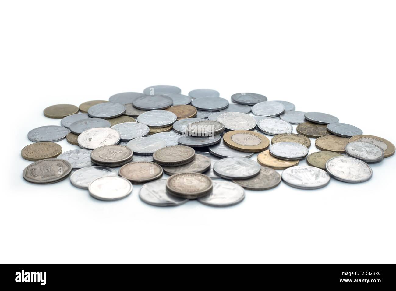 Indian rupee coins scattered on white backgrounds Stock Photo - Alamy