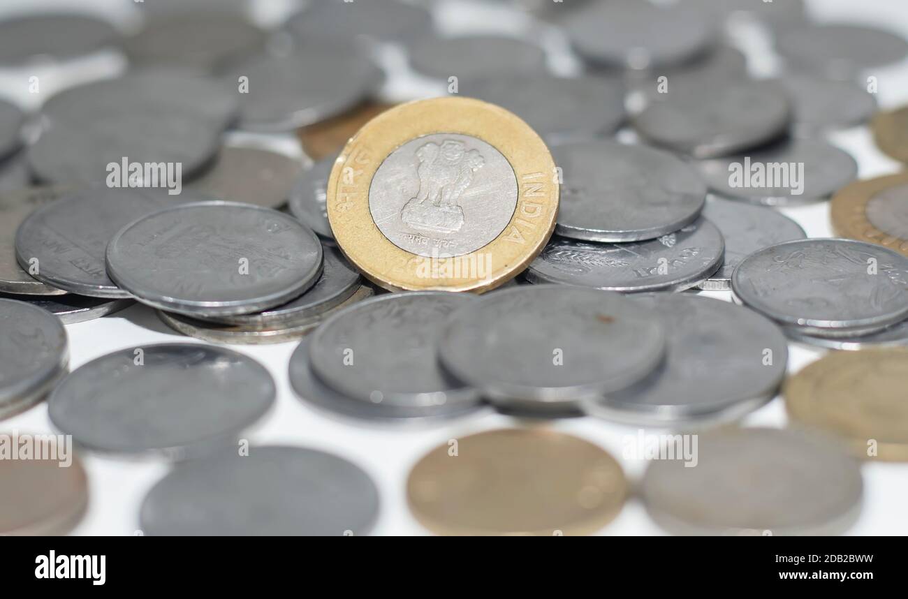 Indian rupee coins scattered on white backgrounds Stock Photo - Alamy